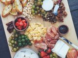 Cheese Board With Fruit Nuts Olives And Prosciutto Recipe The Feedfeed