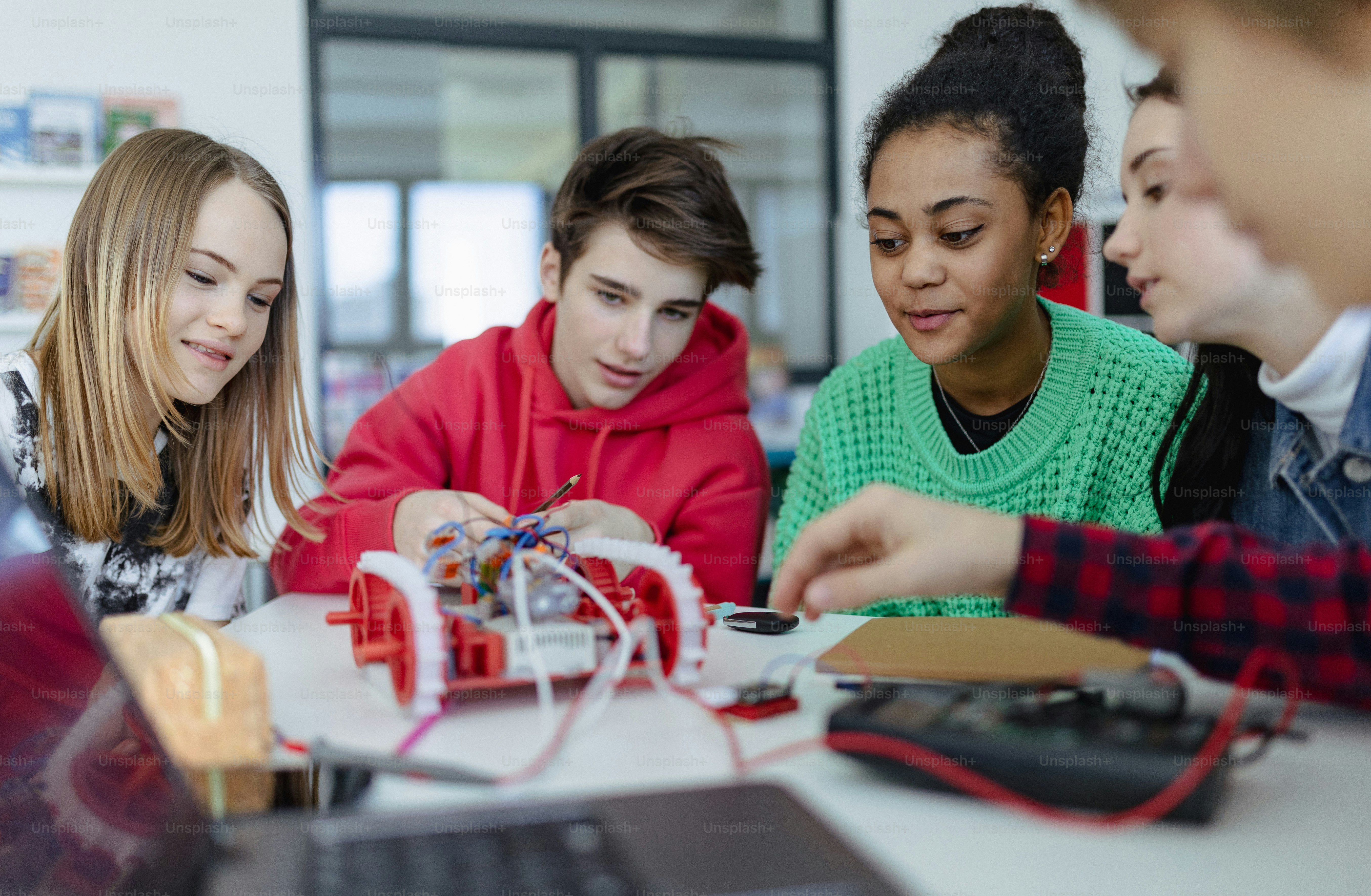 A Group Of High School Students Building And Programming Electric Toys