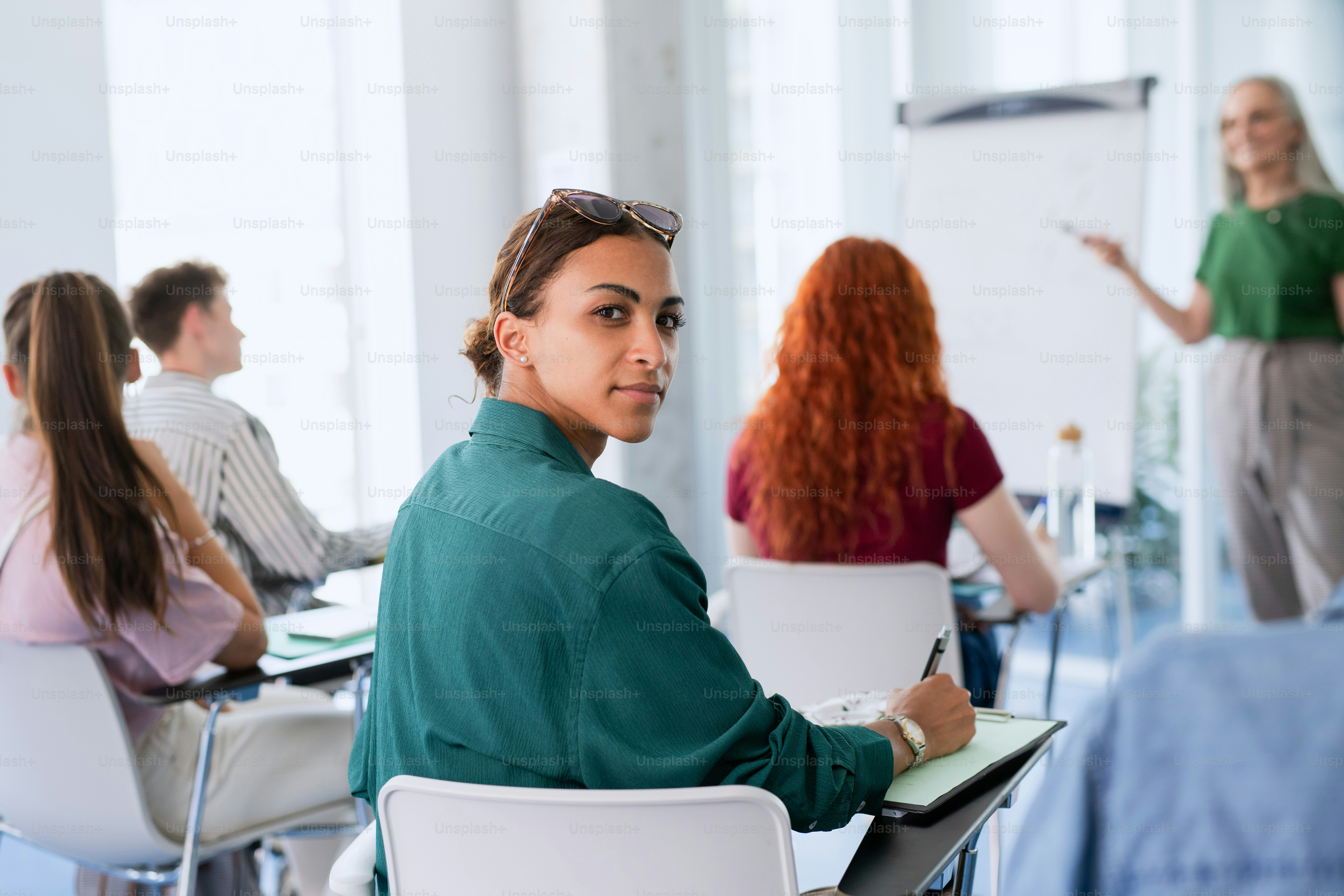 A Portrait Of Young University Student Sitting In Classroom Indoors