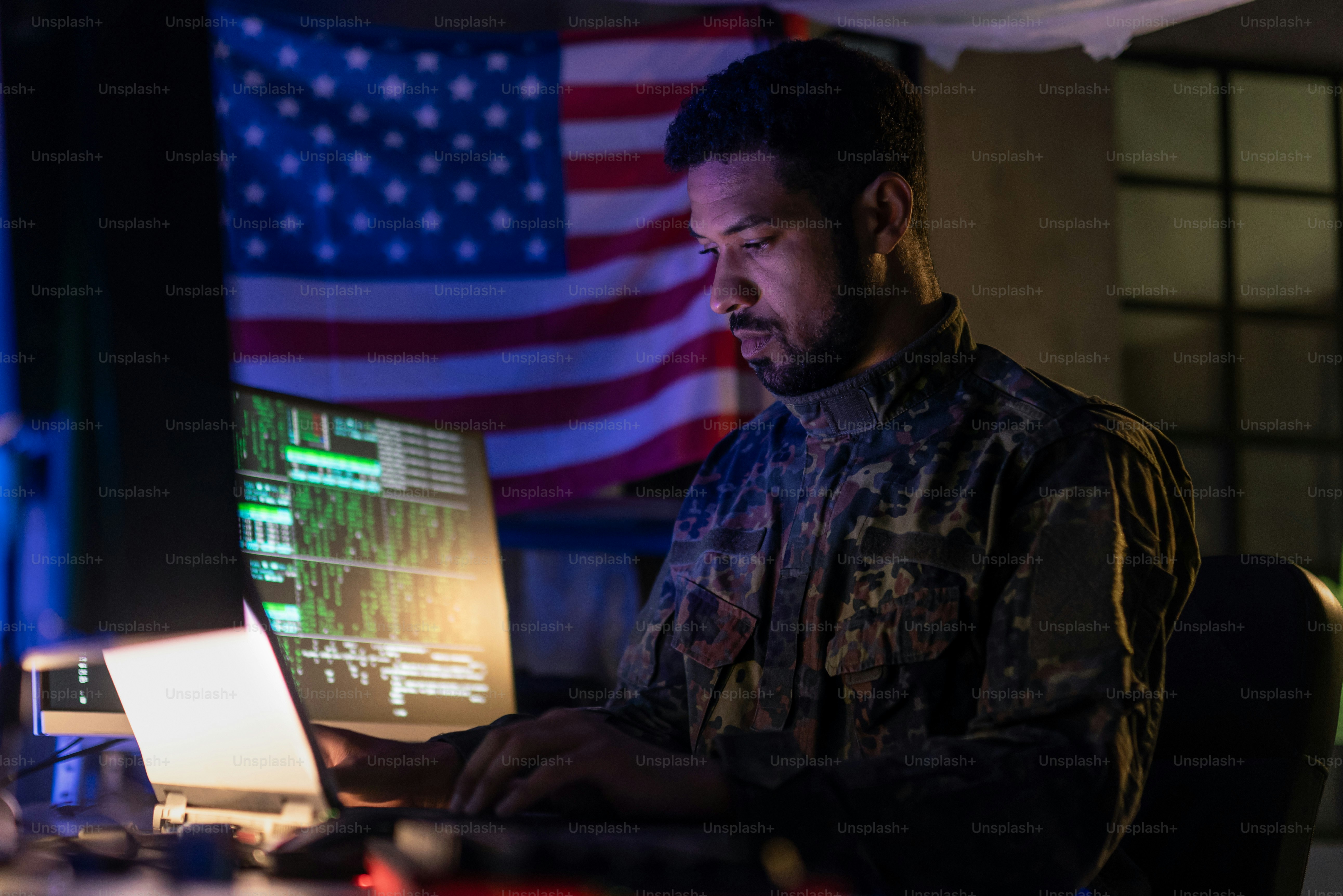A Hacker In Military Unifrorm On Dark Web Cyberwar Concept Photo