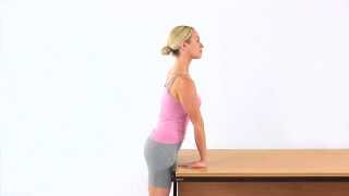 Using a  table to stretch your wrist into extension